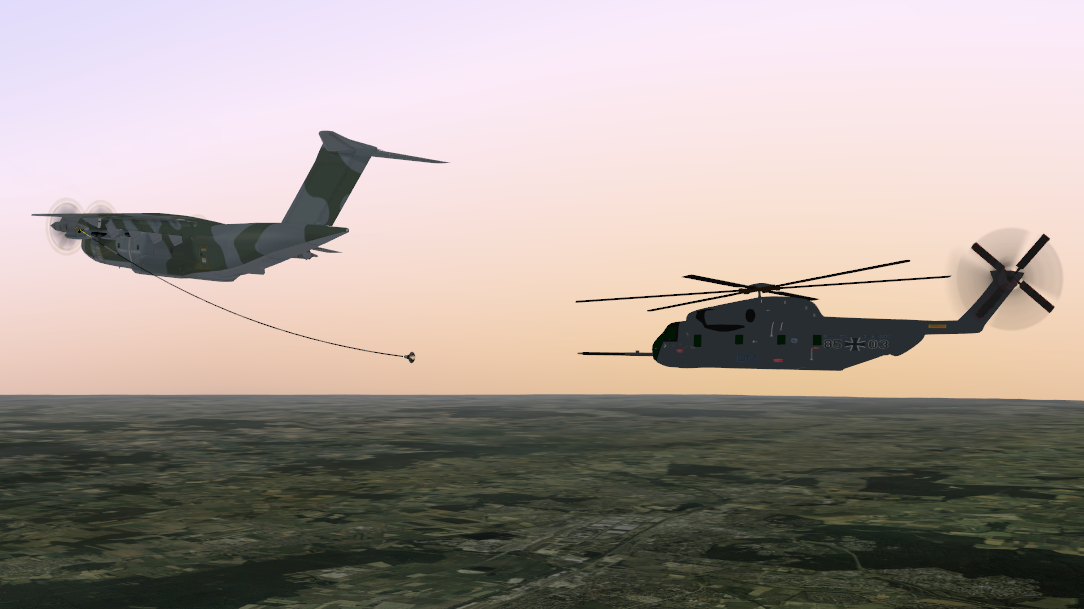 Formation flight preceding helicopter air-to-air refueling at dawn ...