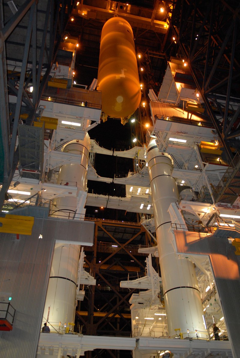 The external tank is lowered toward the solid rocket boosters