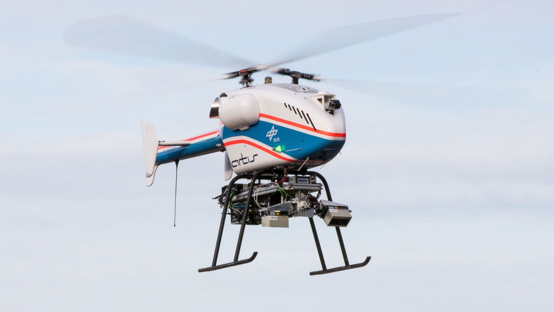 DLR's small and uncrewed superArtis helicopter in flight with payload